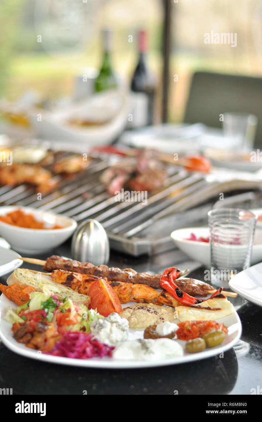 Traditional Cypriot meze and mix meat and chicken kebab table with ...