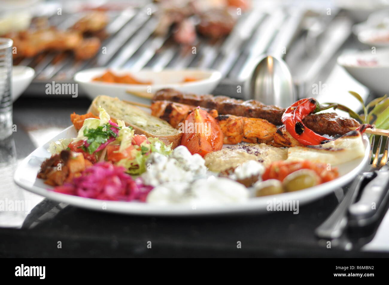 Traditional Cypriot meze and mix meat and chicken kebab table with ...
