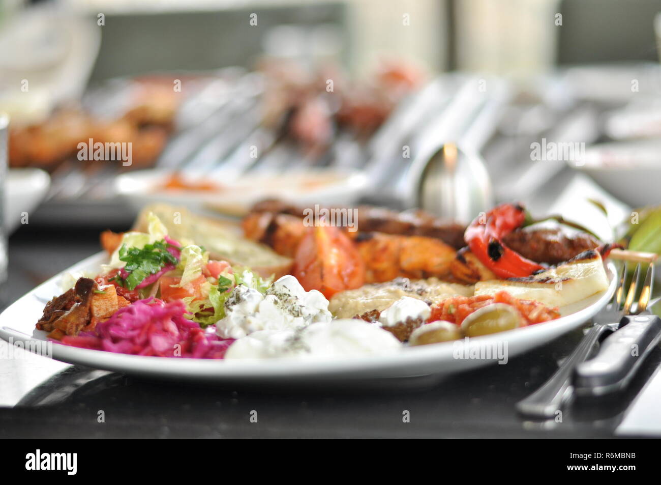 Traditional Cypriot meze and mix meat and chicken kebab table with ...