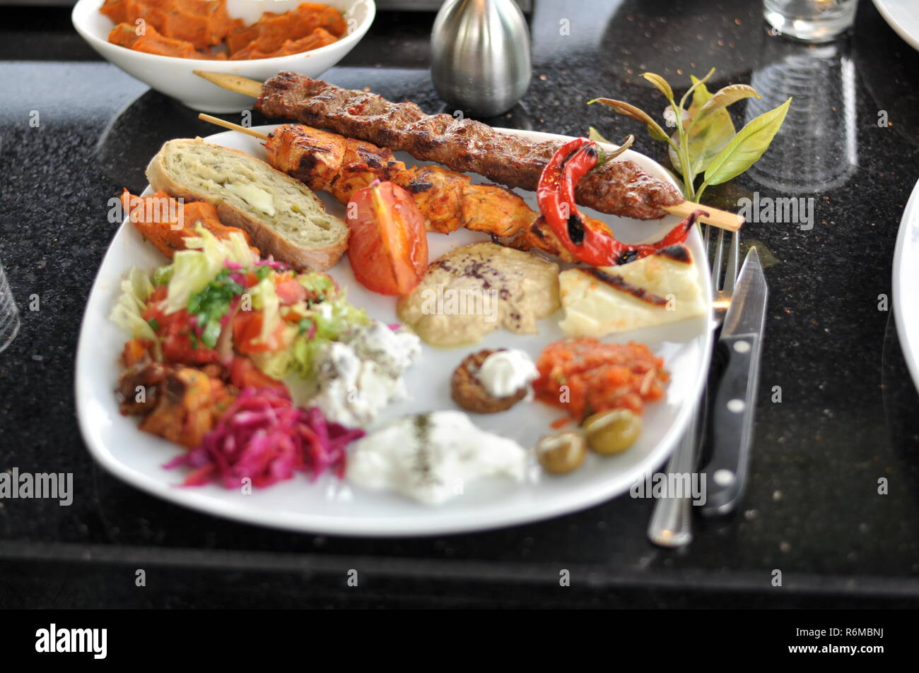 Traditional Cypriot meze and mix meat and chicken kebab table with ...