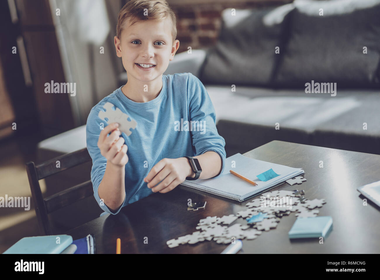 Joyful pupil demonstrating his game Stock Photo - Alamy