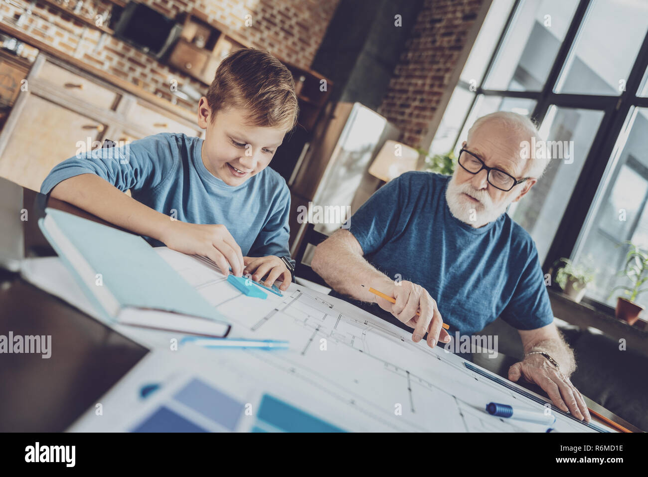 Attentive boy staring at project work Stock Photo - Alamy
