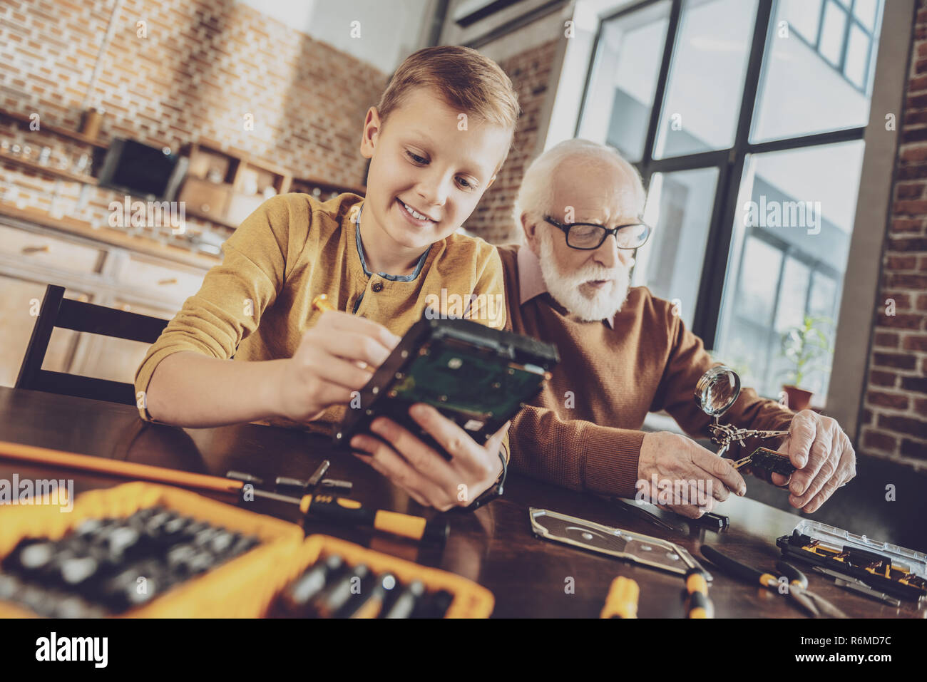 Kind boy trying to repair radio Stock Photo - Alamy