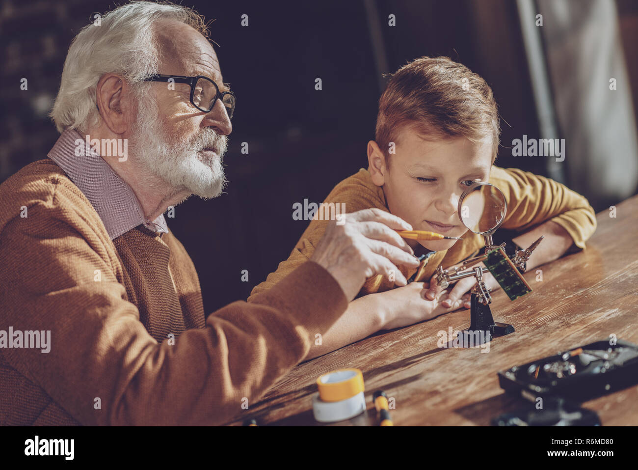 Serious retirement sitting in semi position Stock Photo - Alamy