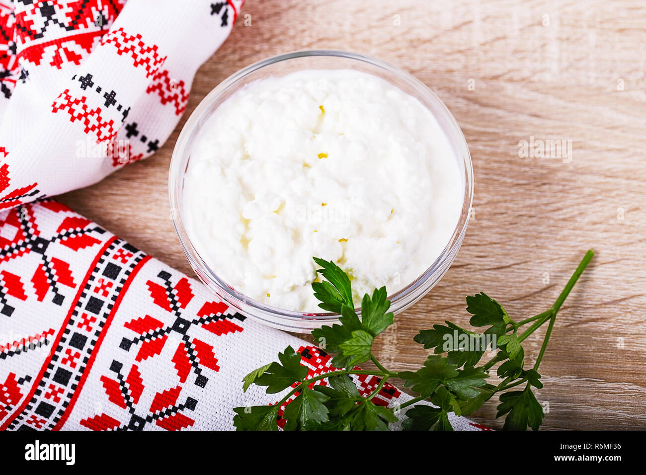 A fresh ricotta cheese with parsley leaf on white marble table, italian ...