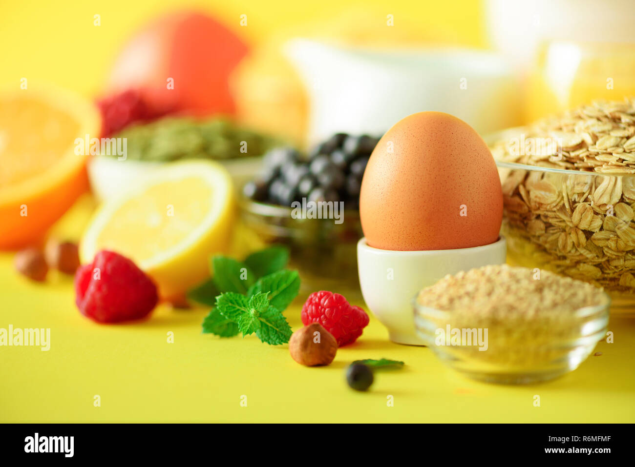 Delicious breakfast ingredients. Soft boiled egg, oat flakes, nuts ...