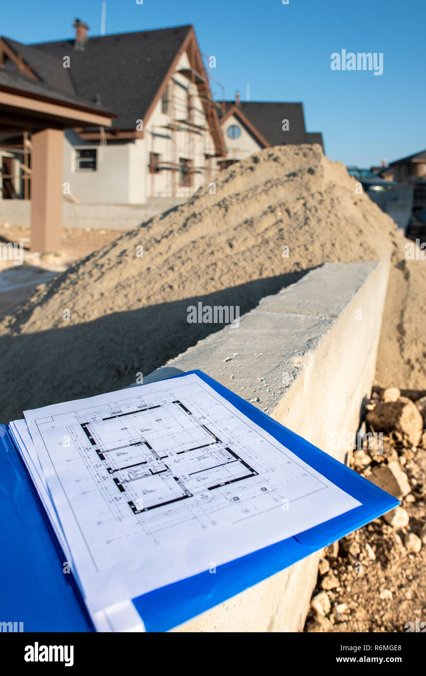 New build house and blueprints. Construction site Stock Photo - Alamy
