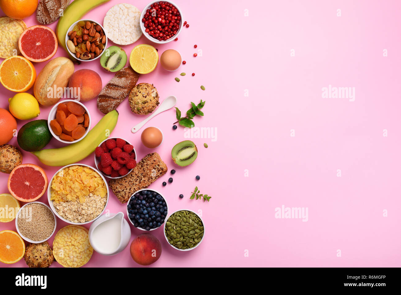 Organic food frame. Healthy breakfast ingredients. Oat and corn flakes ...