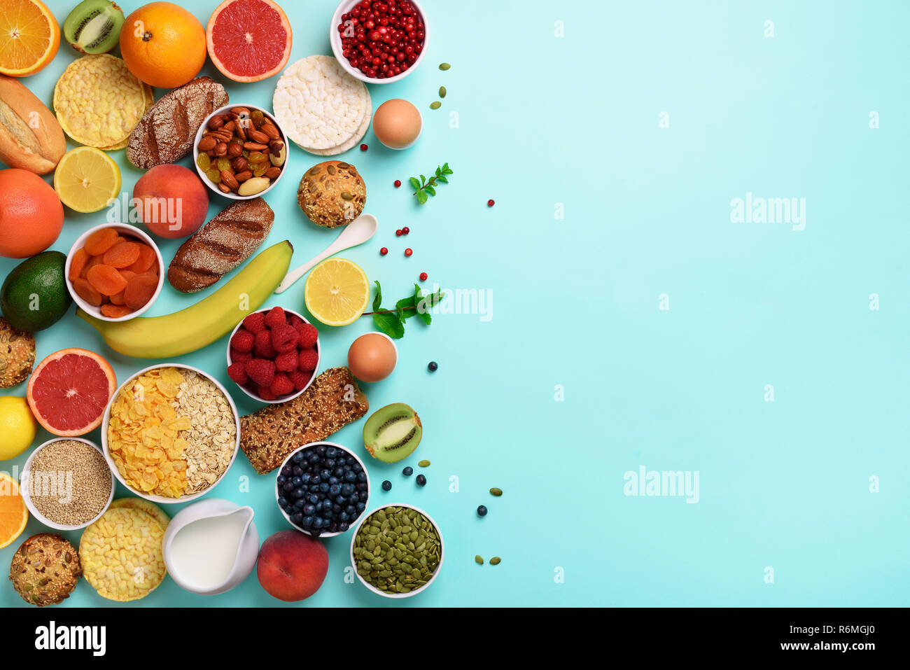 Organic food frame. Healthy breakfast ingredients. Oat and corn flakes ...