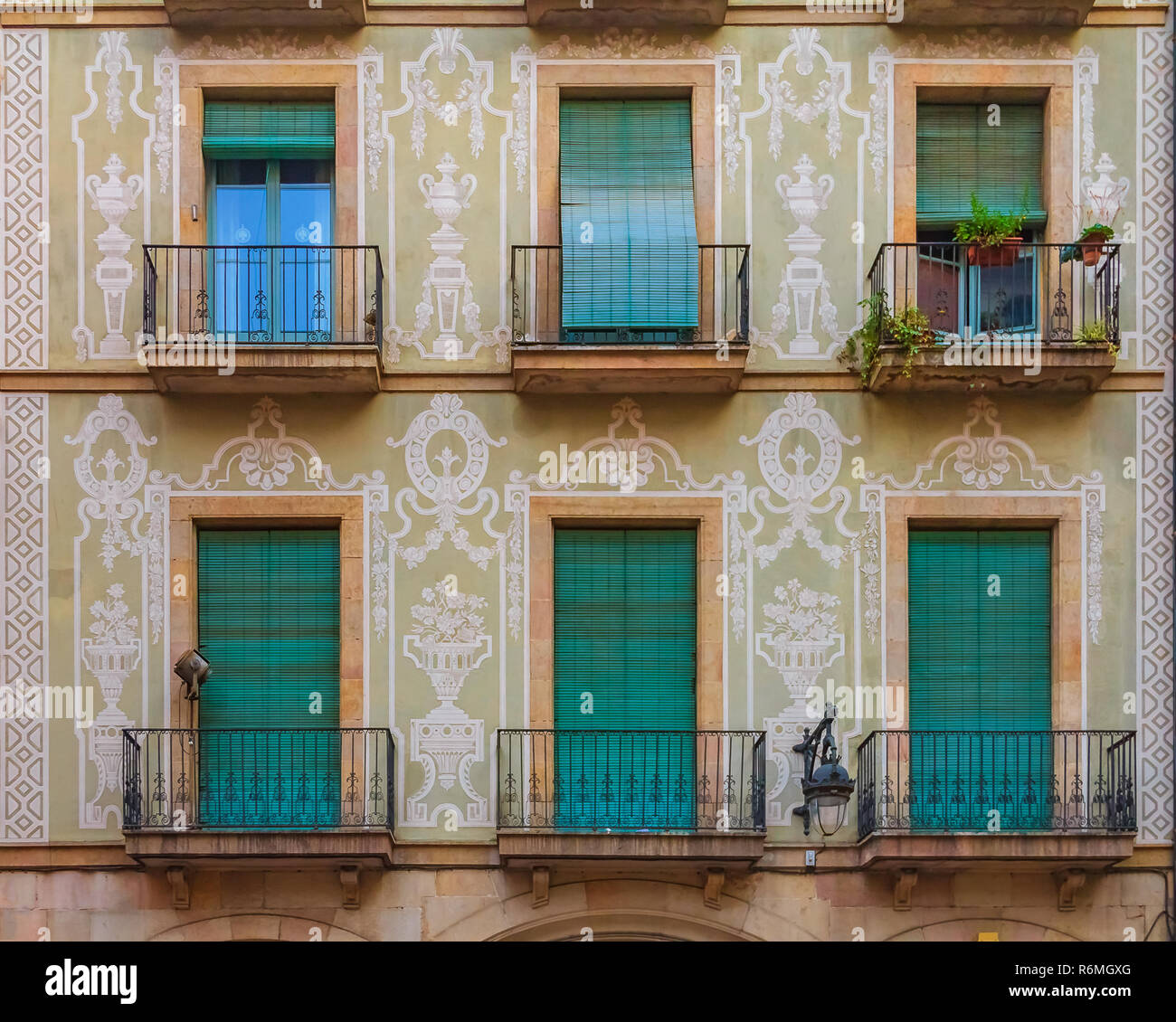 Ornate painted residential building facade and windows with green ...