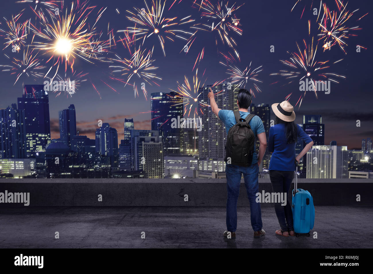 Young asian couple enjoying fireworks on the city Stock Photo - Alamy