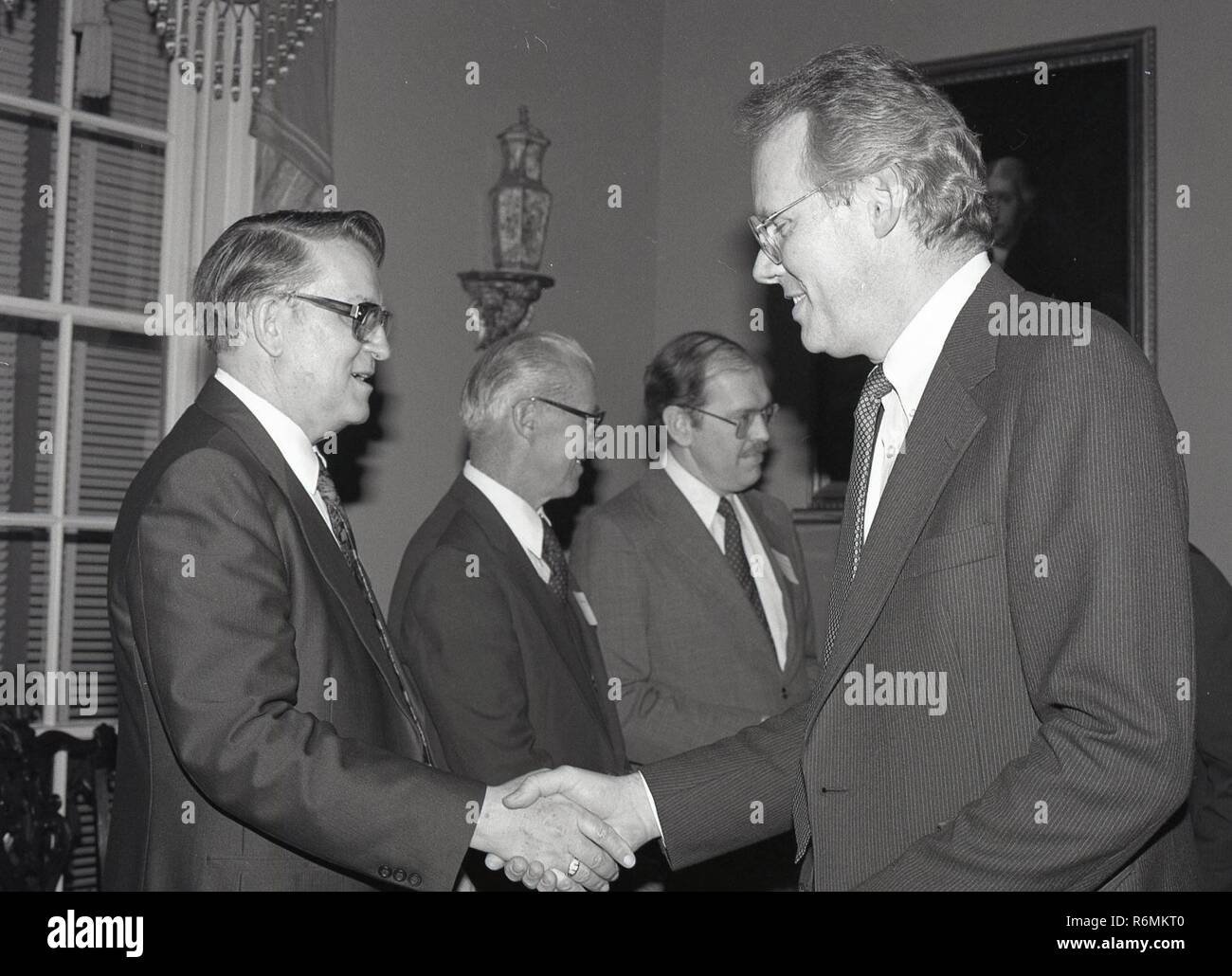 men shaking hands and talking Stock Photo - Alamy