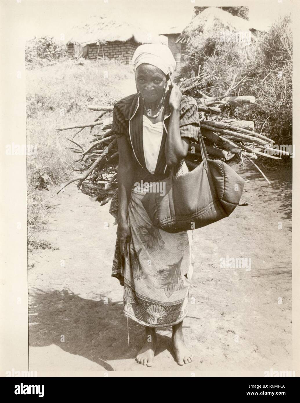 An older woman carrying tree branches Stock Photo - Alamy