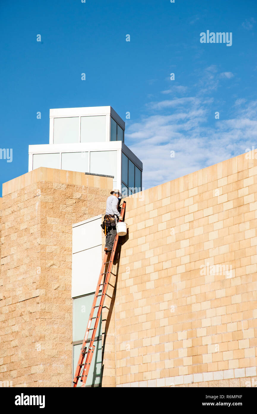 Man climbing tall ladder hi-res stock photography and images - Alamy