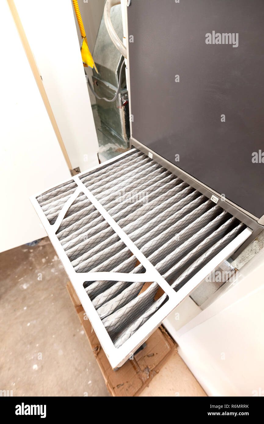 replacing a dirty HVAC filter Stock Photo - Alamy