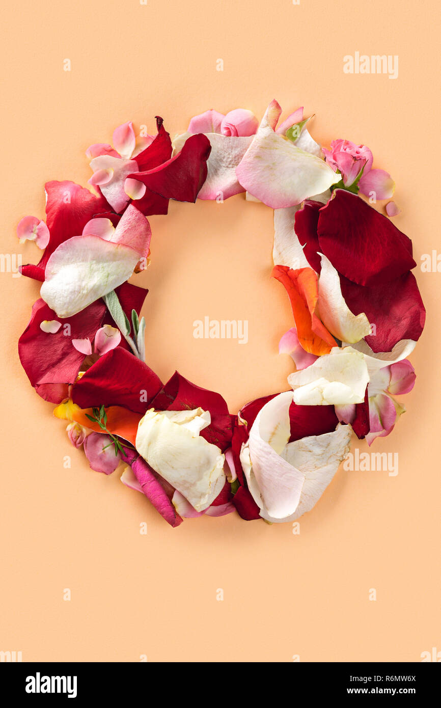 Letter O made from red roses and petals isolated on a white background ...