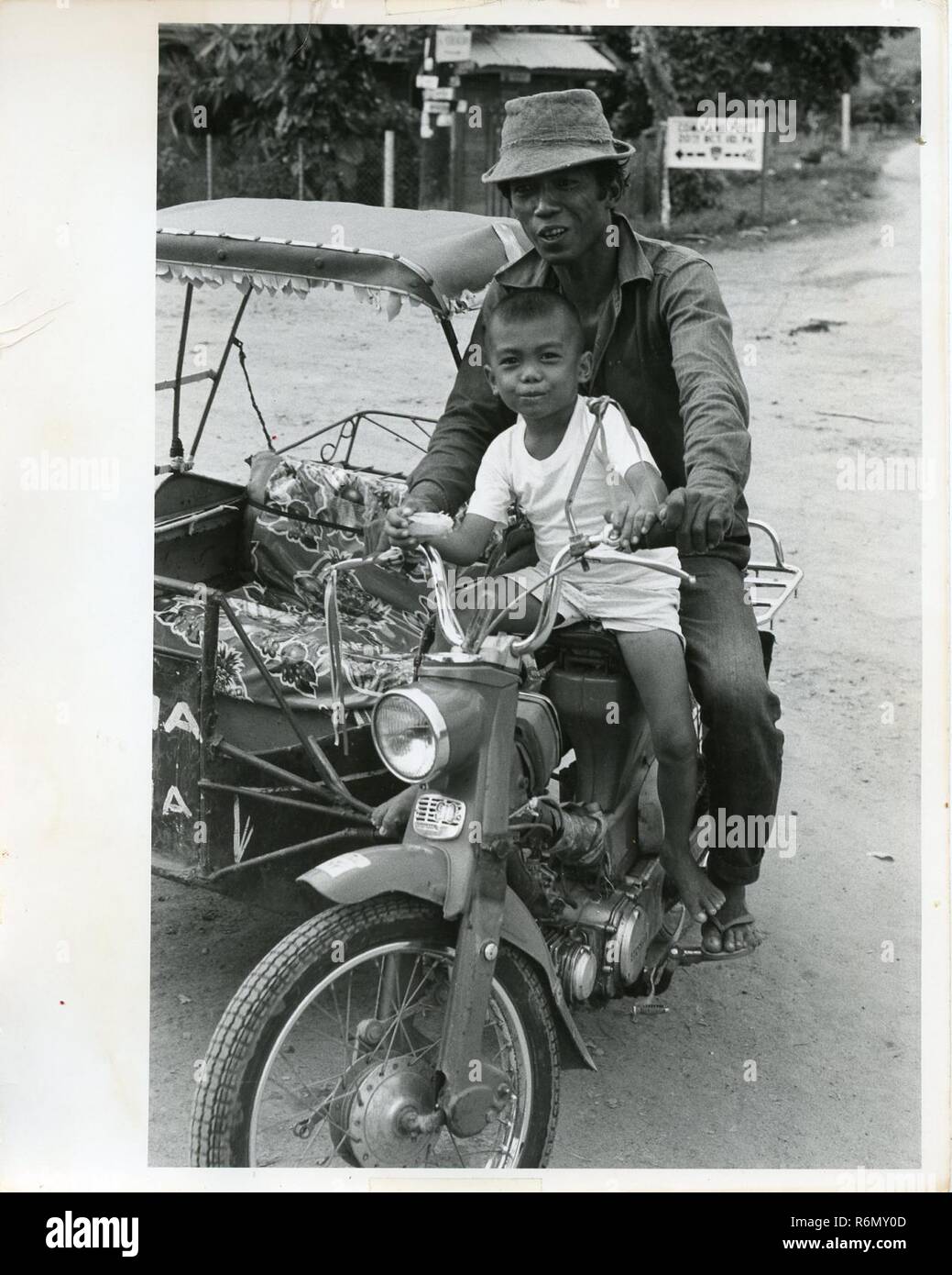 A MAN RIDING A LITTLE BOY ON HIS MOTOR BIKE Stock Photo - Alamy