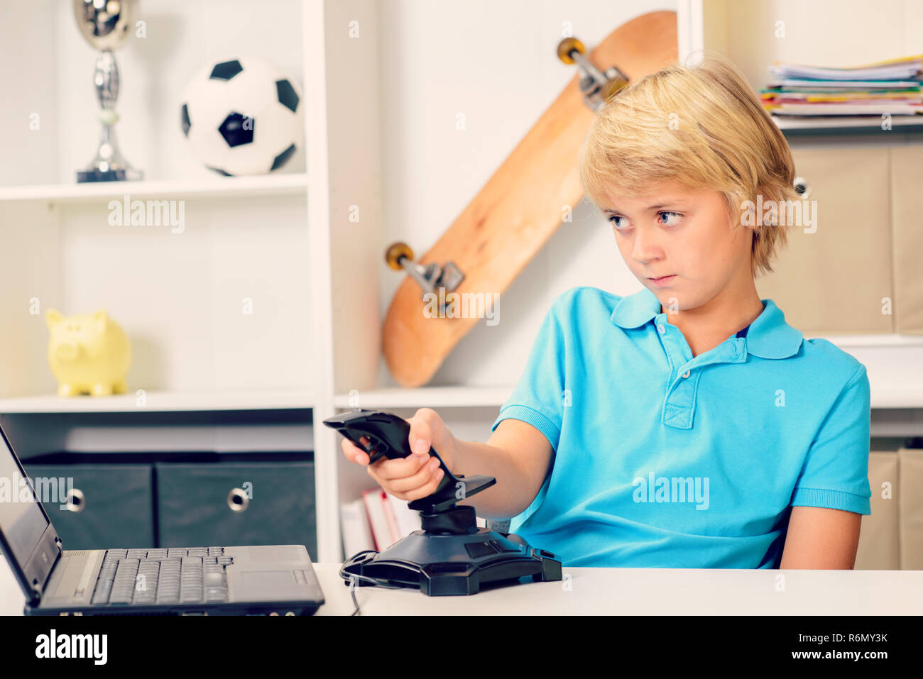 boy is playing computer game Stock Photo - Alamy