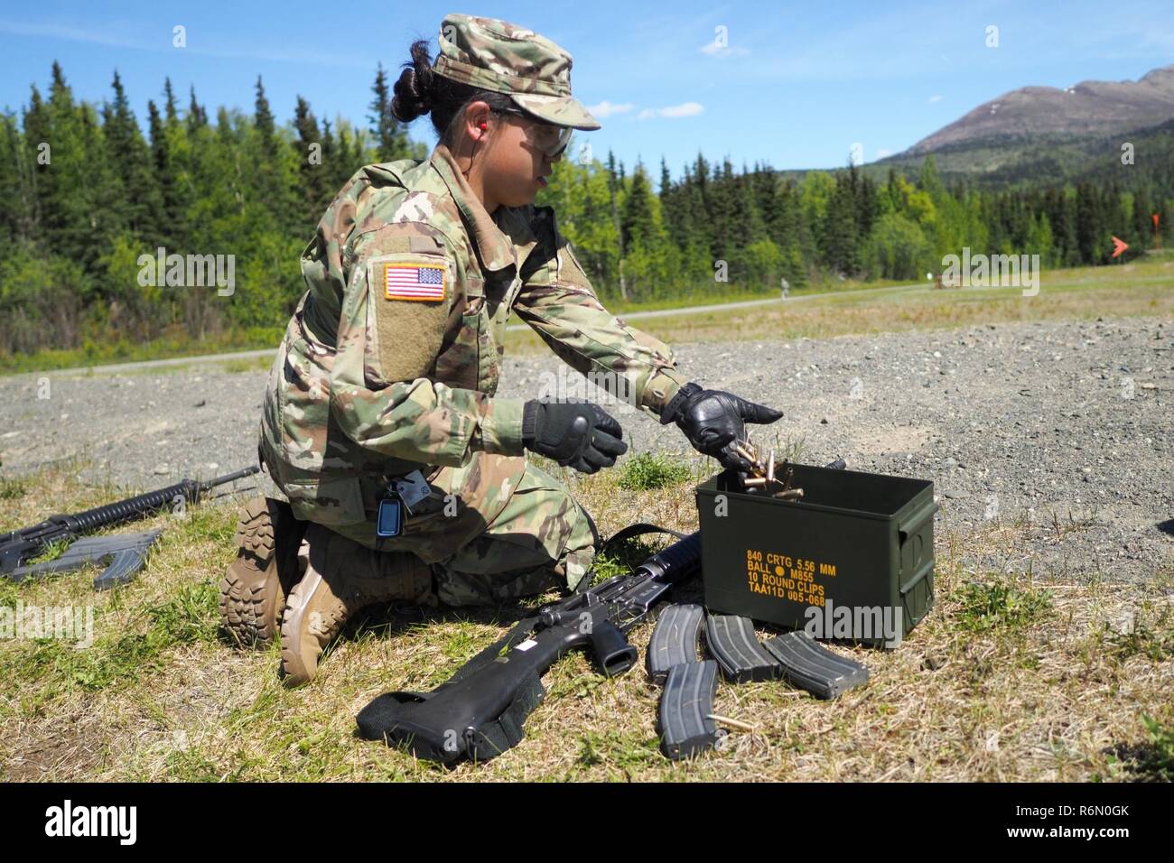 Spc. Anaya Hokoana, a native of Hilo, Hawaii, fills an empty ammunition ...