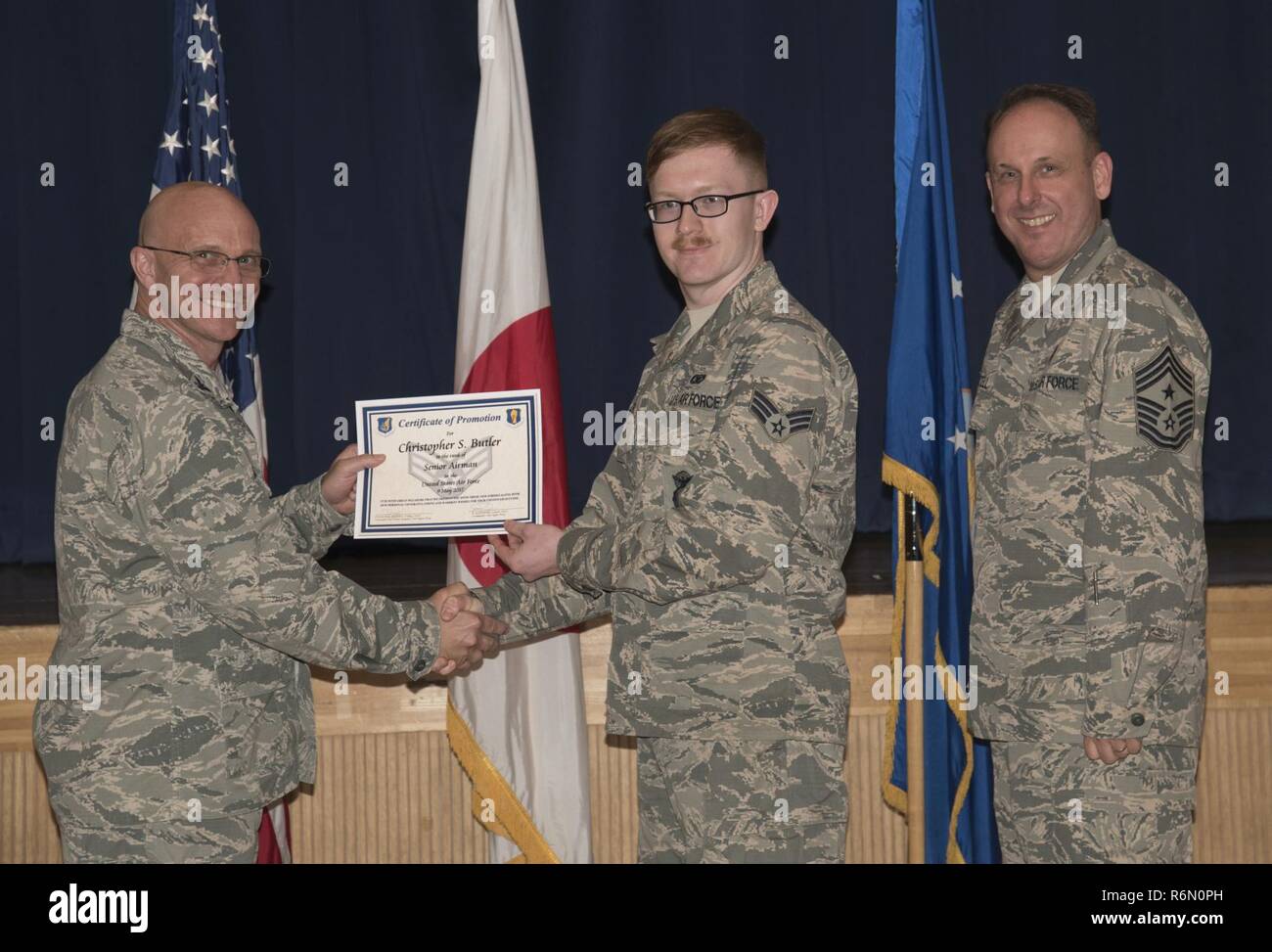 An Airman receives their certificate of promotion at Misawa Air Base ...