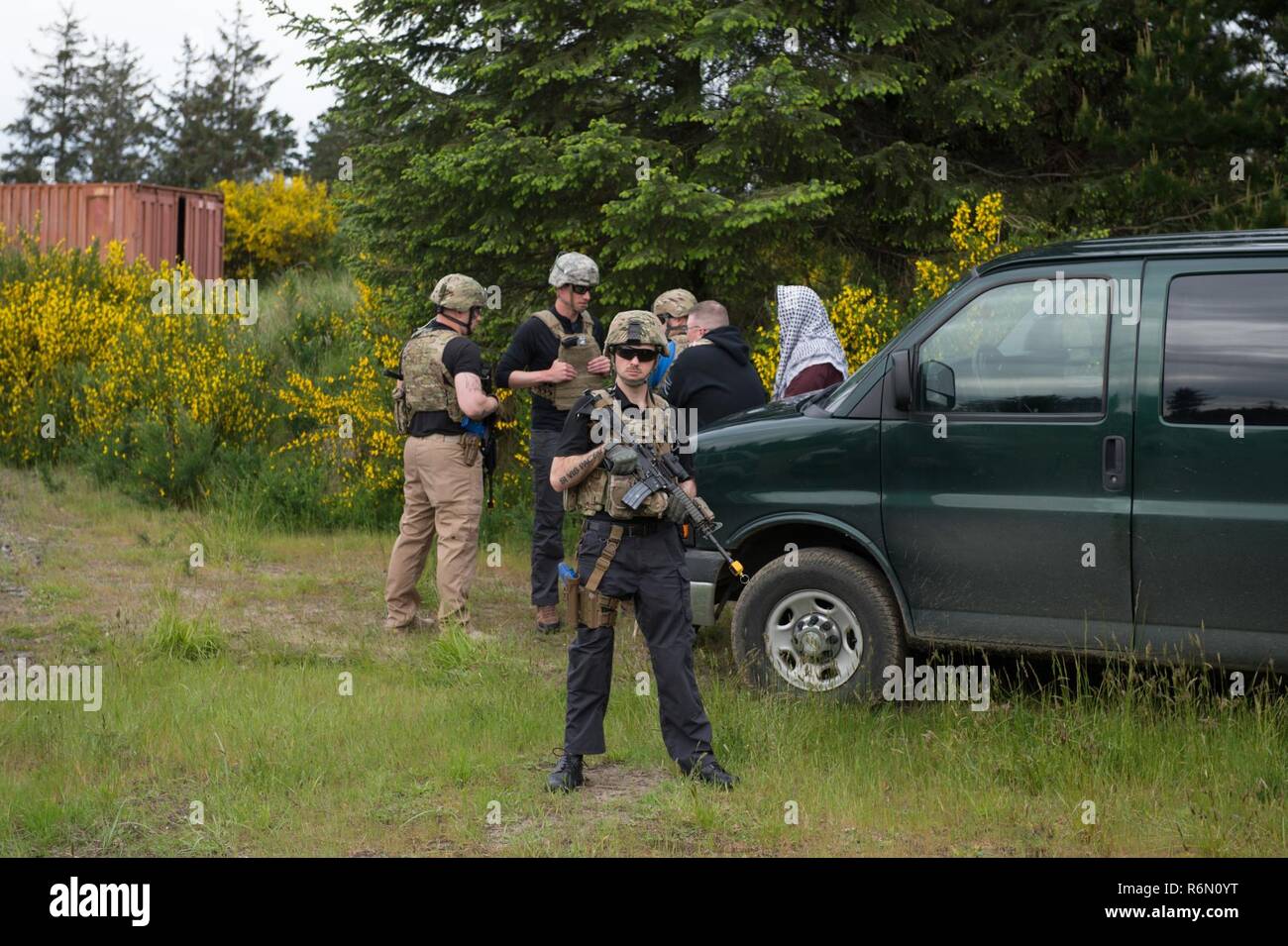 Oregon Army National Guard Sgt. Robert Frey (center), with the 1186th Military Police Company ...