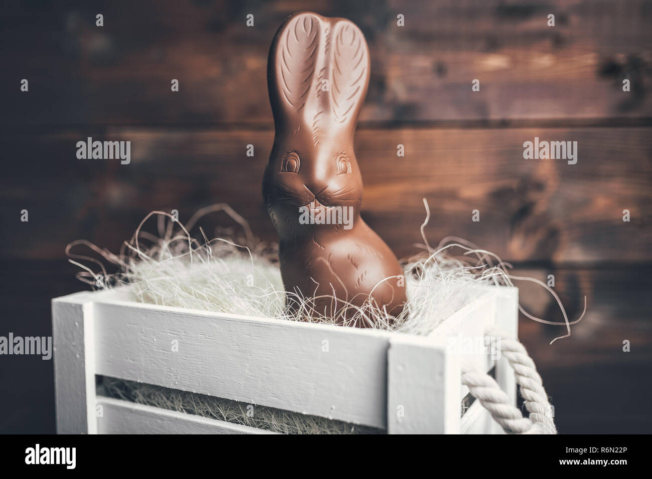 Chocolate Easter bunny inside a basket Stock Photo - Alamy