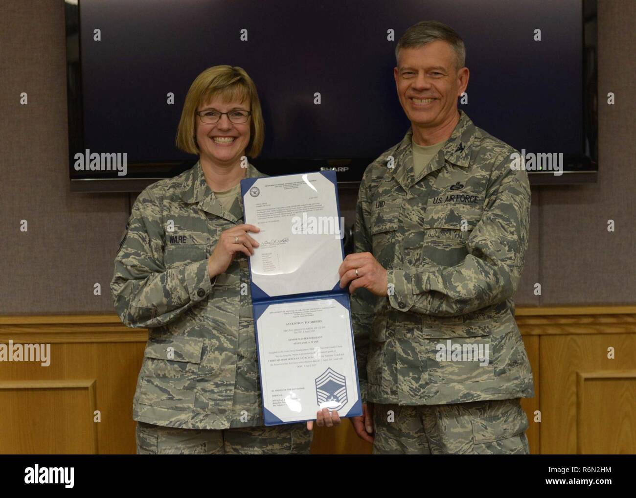U.S. Air National Guard Col. Eric Lind presents Chief Master Sgt ...