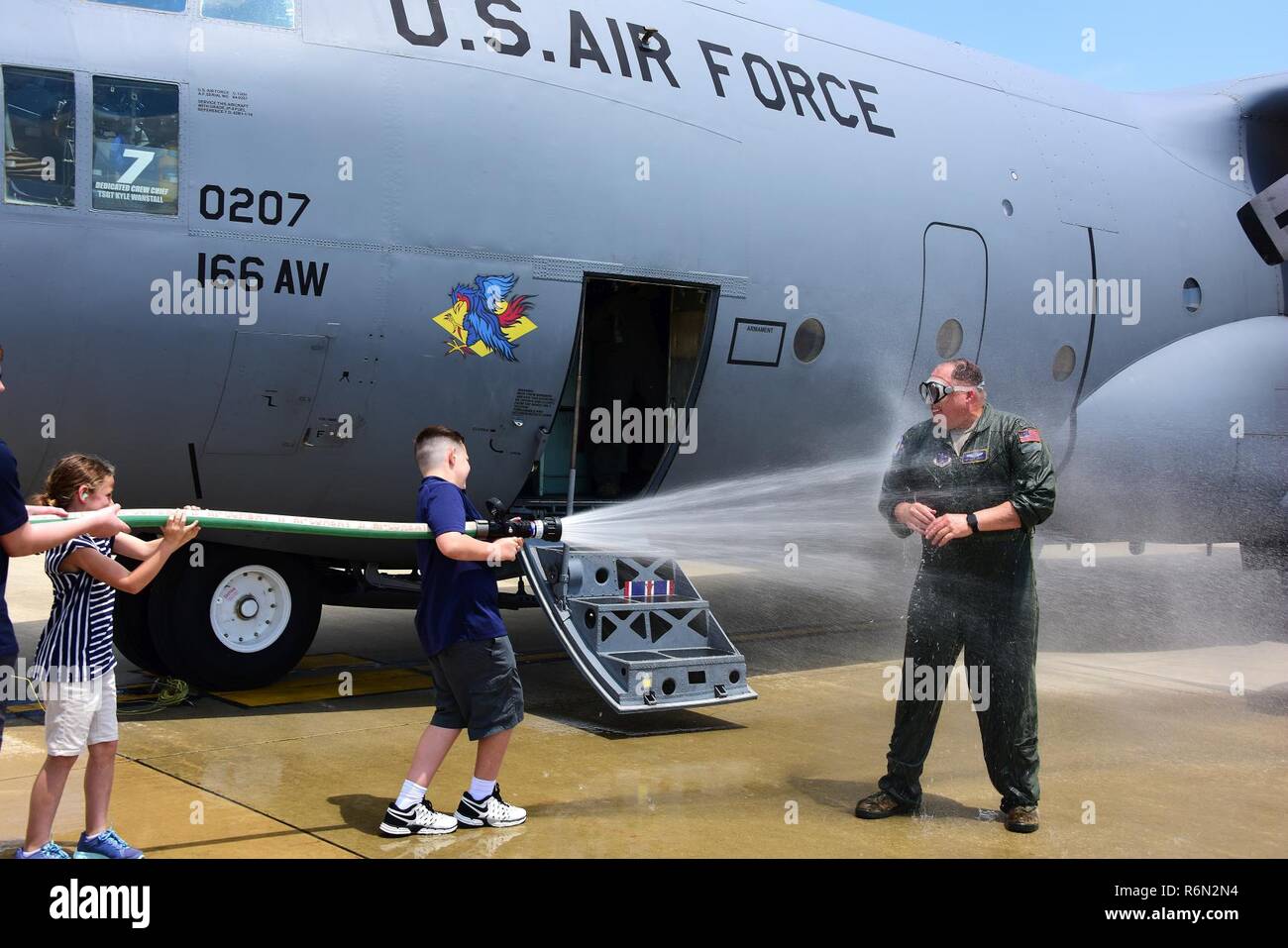 Lt. Col. Arne Kolbjornsen, pilot, 142nd Airlift Squadron is hosed down ...