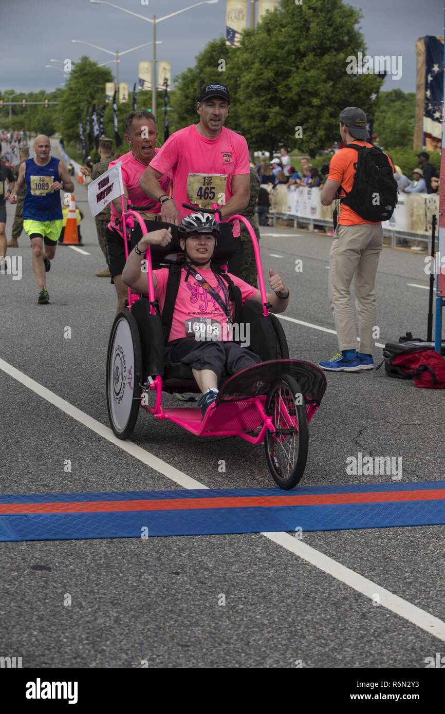 Chris Chalkley, right, pushes a stroller with Benjamin Tritt, left ...