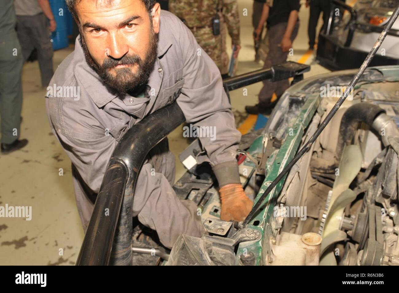 KABUL, Afghanistan – An Afghan mechanic conducts vehicle maintenance at ...