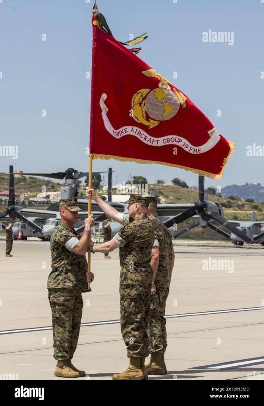 Sgt. Maj. Chad Butts passes the Marine Air Group (MAG) 39 hands colors ...