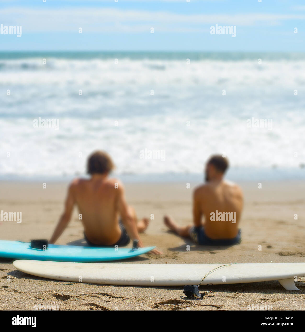 Surfers rest on the beach Stock Photo - Alamy