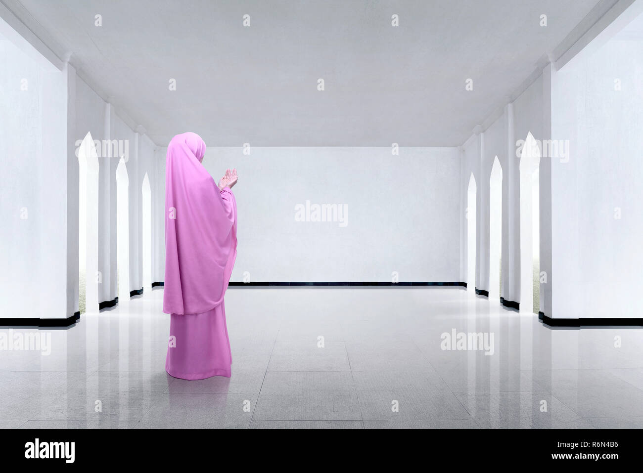 Back view of asian muslim woman raising hand and praying Stock Photo ...