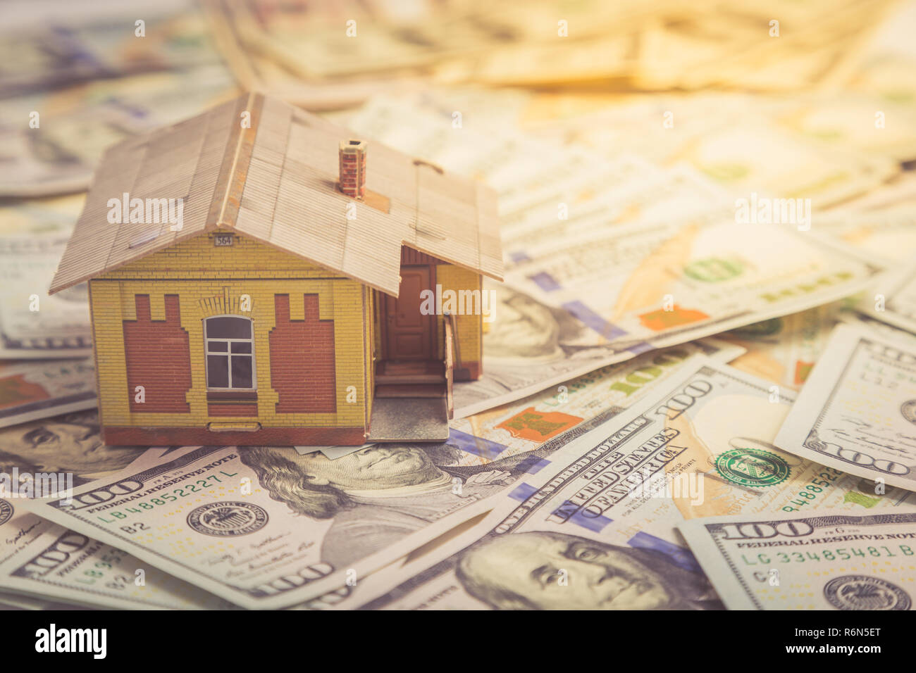 Mortgage concept. house and money. Miniature house model on pile of ...