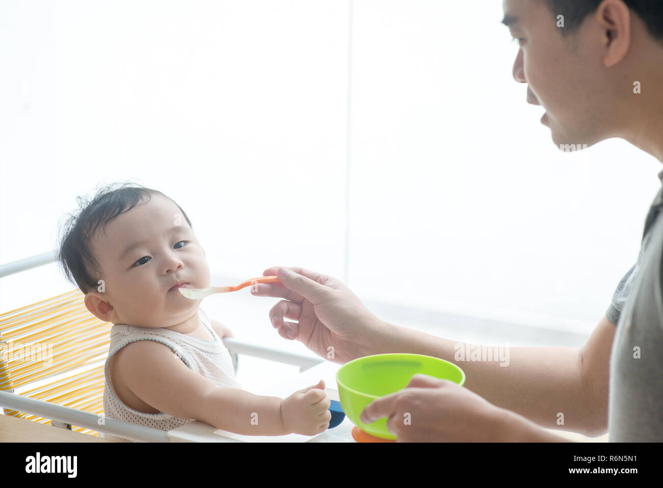 Father feeding child food Stock Photo - Alamy