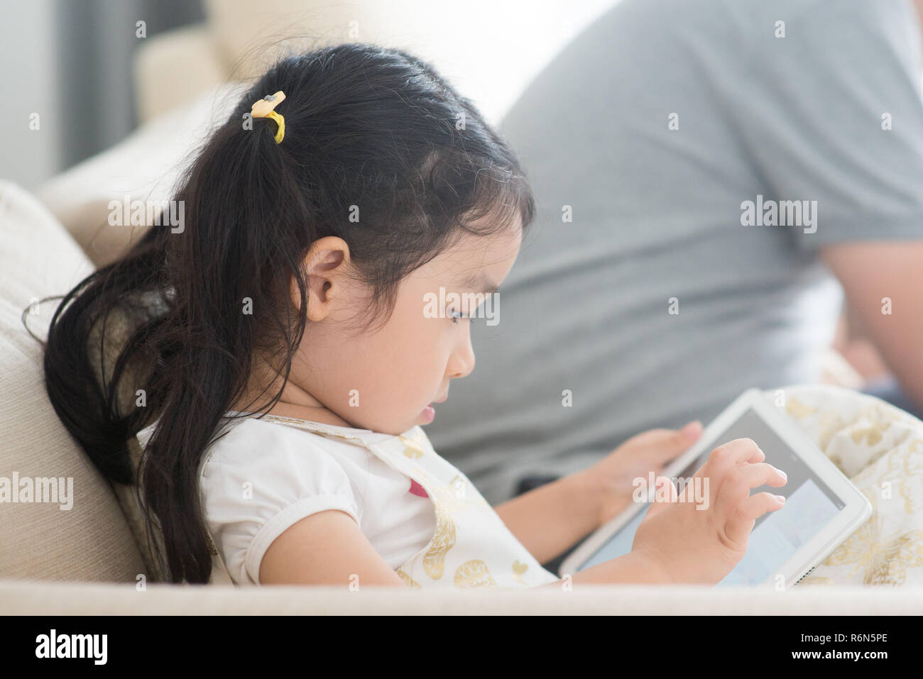 Little girl using digital tablet Stock Photo - Alamy