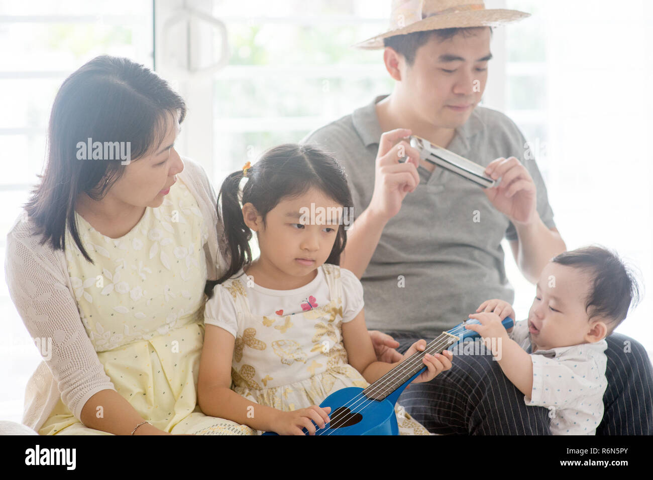 Chinese kids playing musical instrument hi-res stock photography and ...