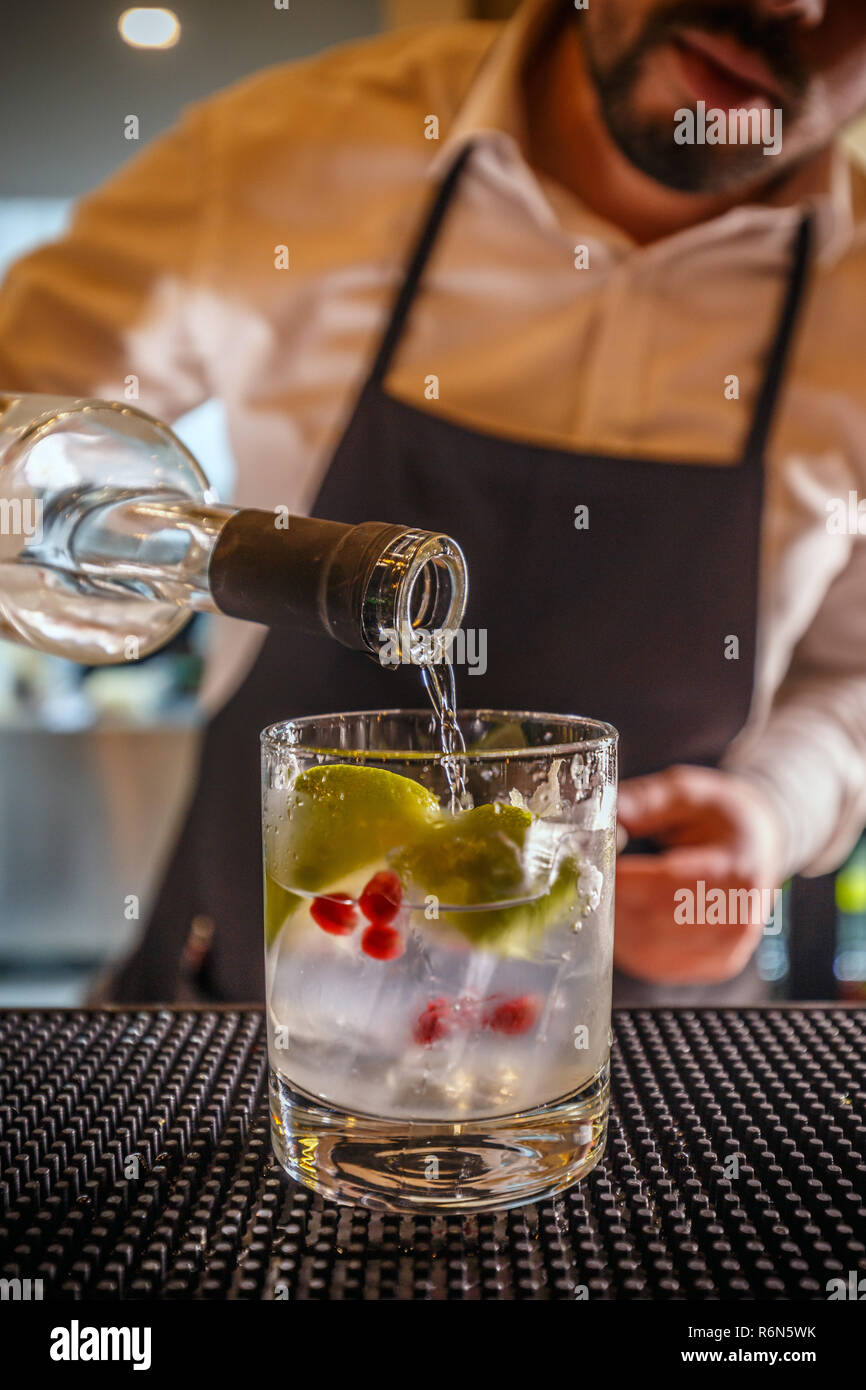 Bartender pouring vodka Stock Photo - Alamy