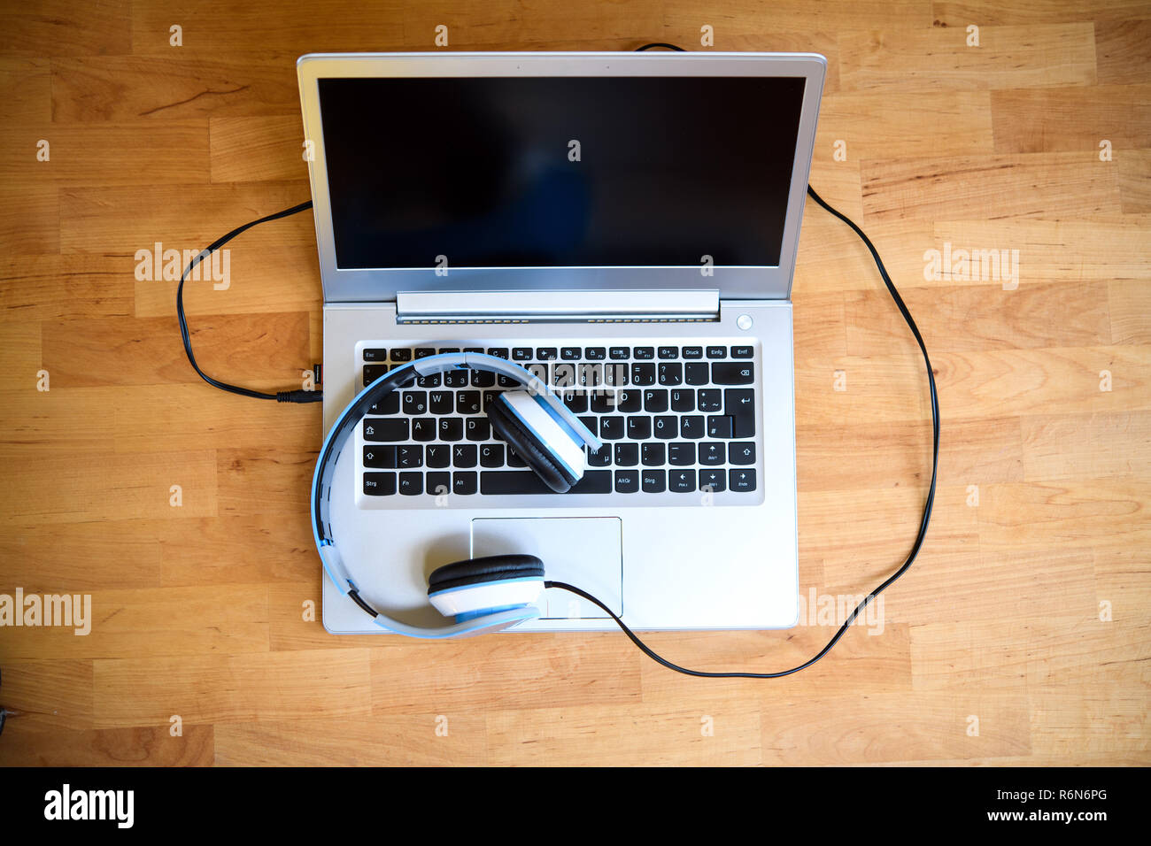 computer with headphones on wooden ground from above Stock Photo - Alamy