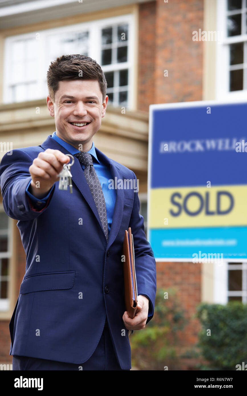 Male Realtor Standing Outside Residential Property Holding Keys Stock ...