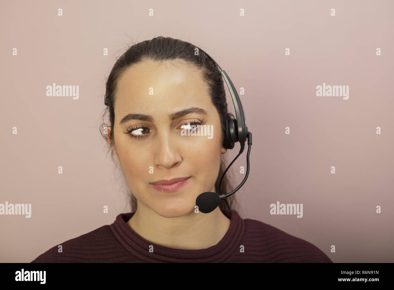 Thoughtful call center operator taking a cal Stock Photo - Alamy