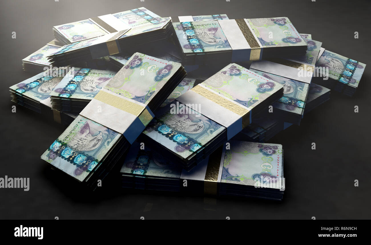 A pile of randomly scattered bundles of UAE dirham banknotes on an ...