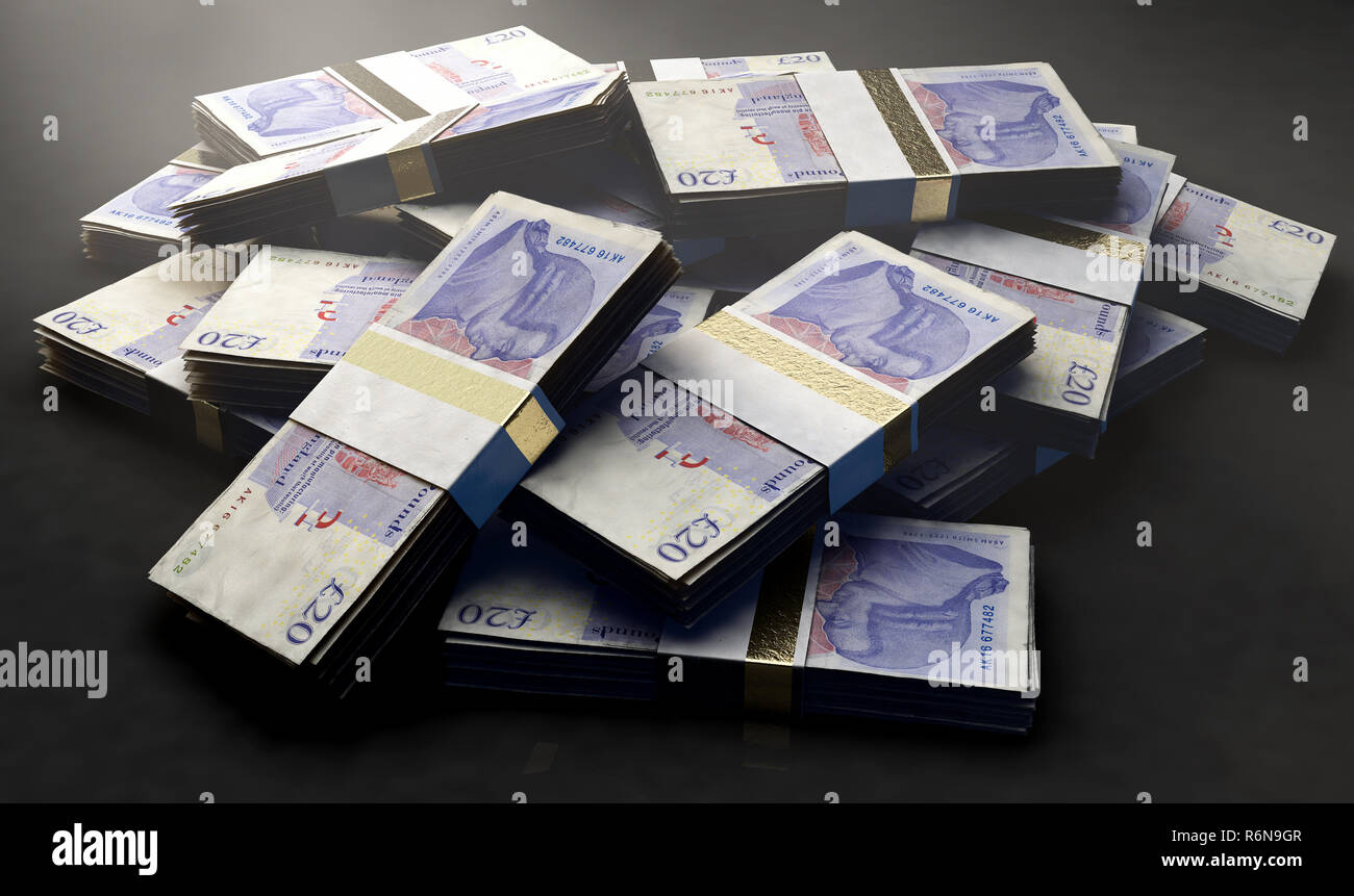 A pile of randomly scattered bundles of british pound banknotes on an ...