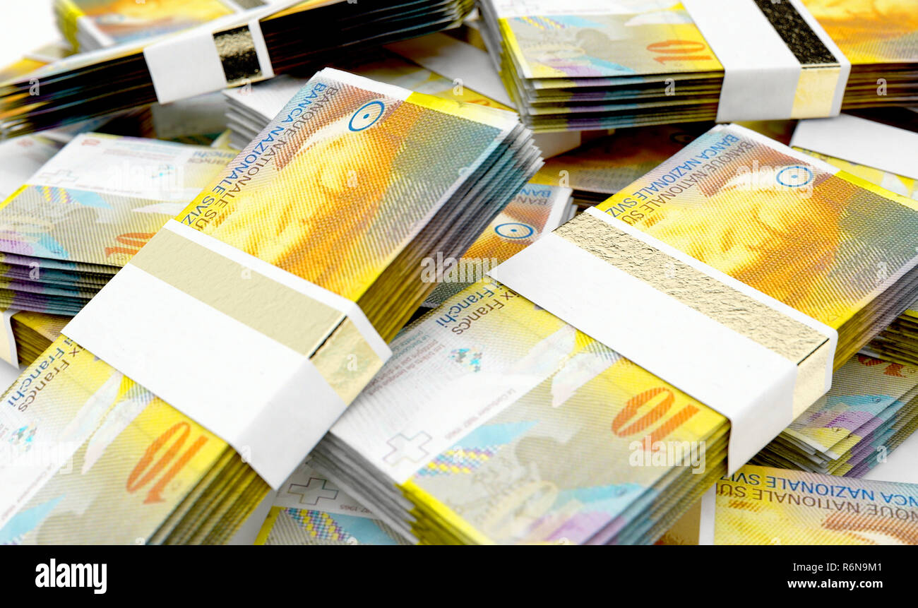 A pile of randomly scattered bundles of swiss franc banknotes on an ...