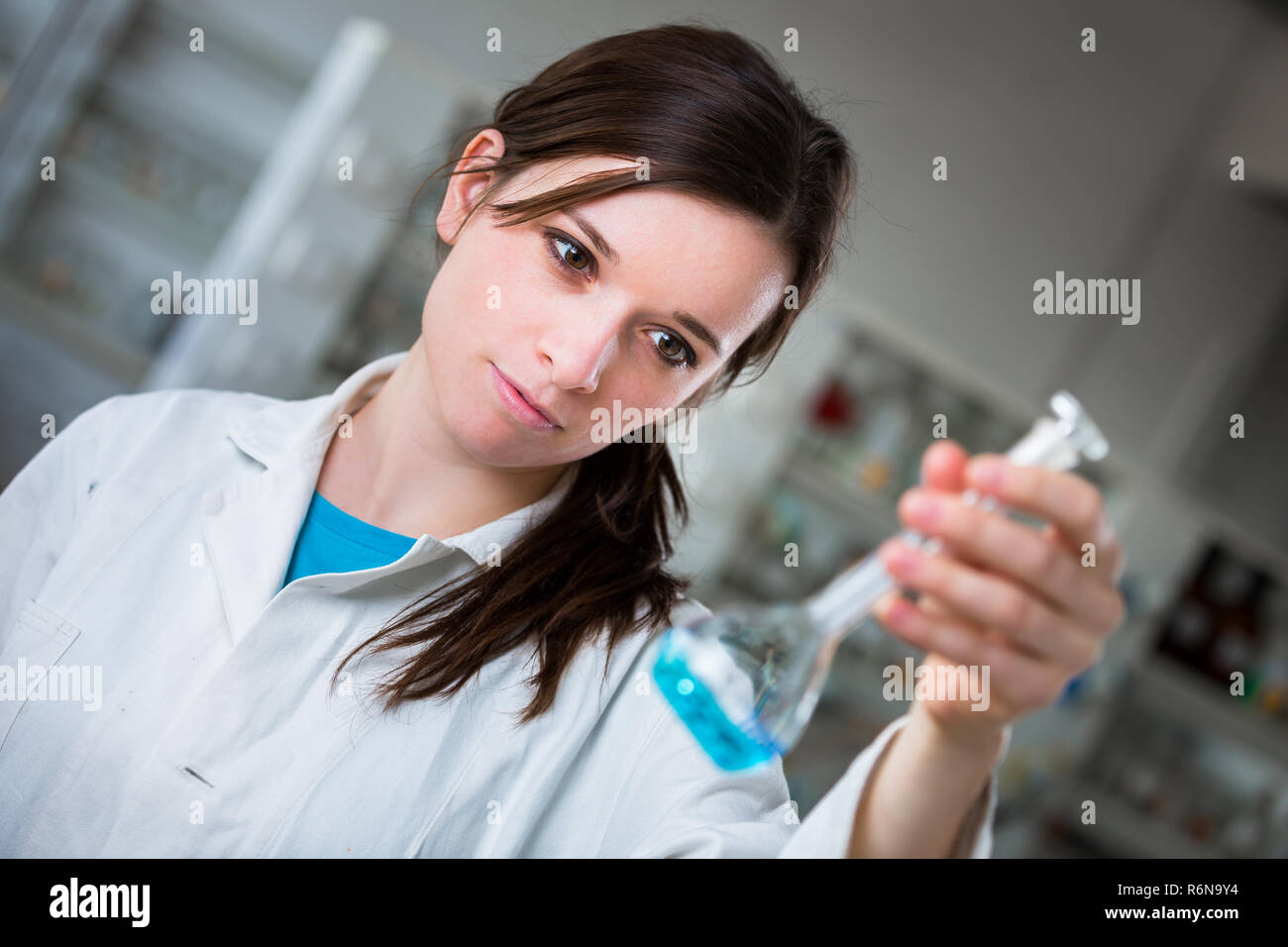 Young, female researcher carrying out experiments in a lab (shallow DOF ...