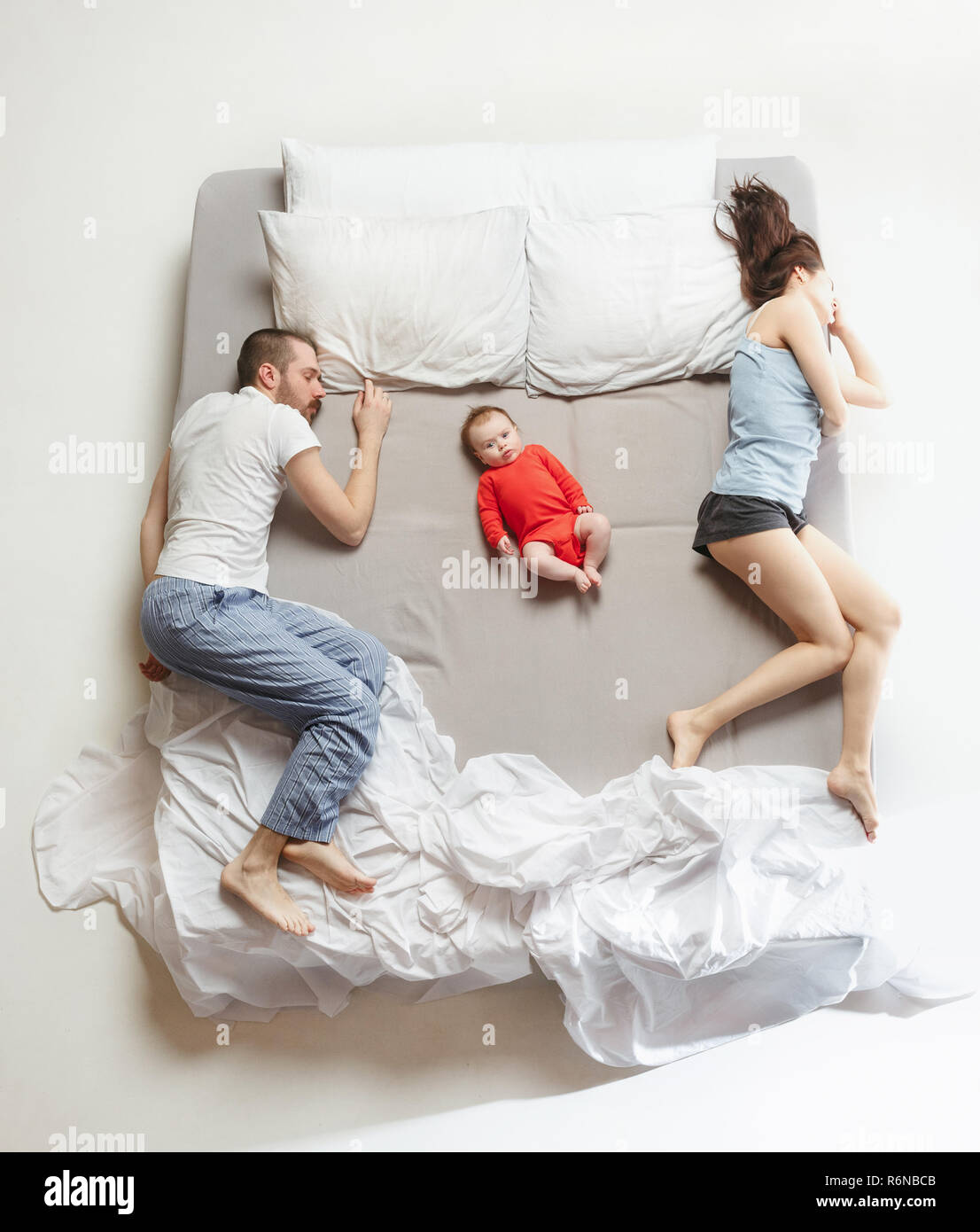 Top view of happy family with one newborn child in bedroom Stock Photo ...