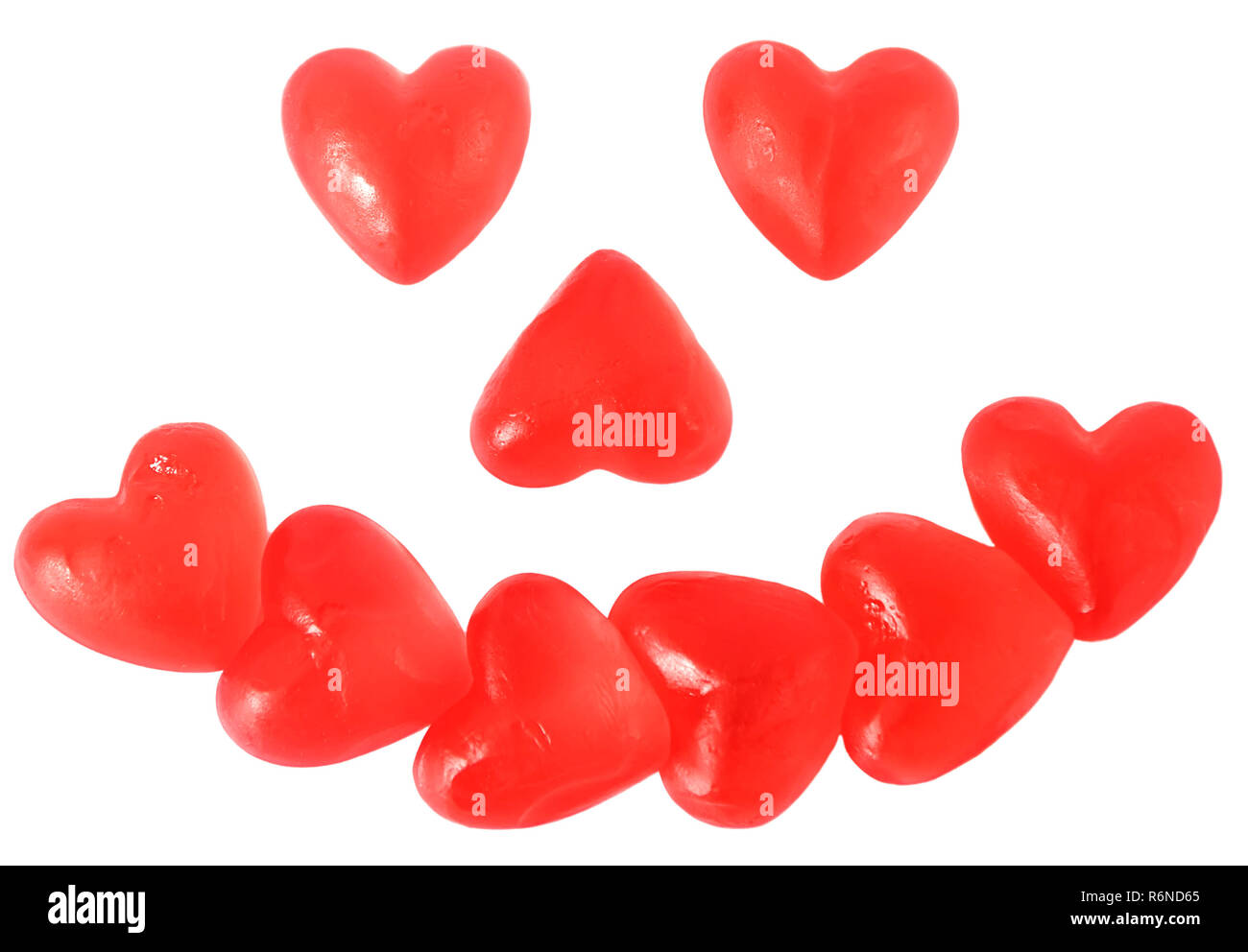Bright red jelly heart shaped sweets in the shape of a smiling happy ...
