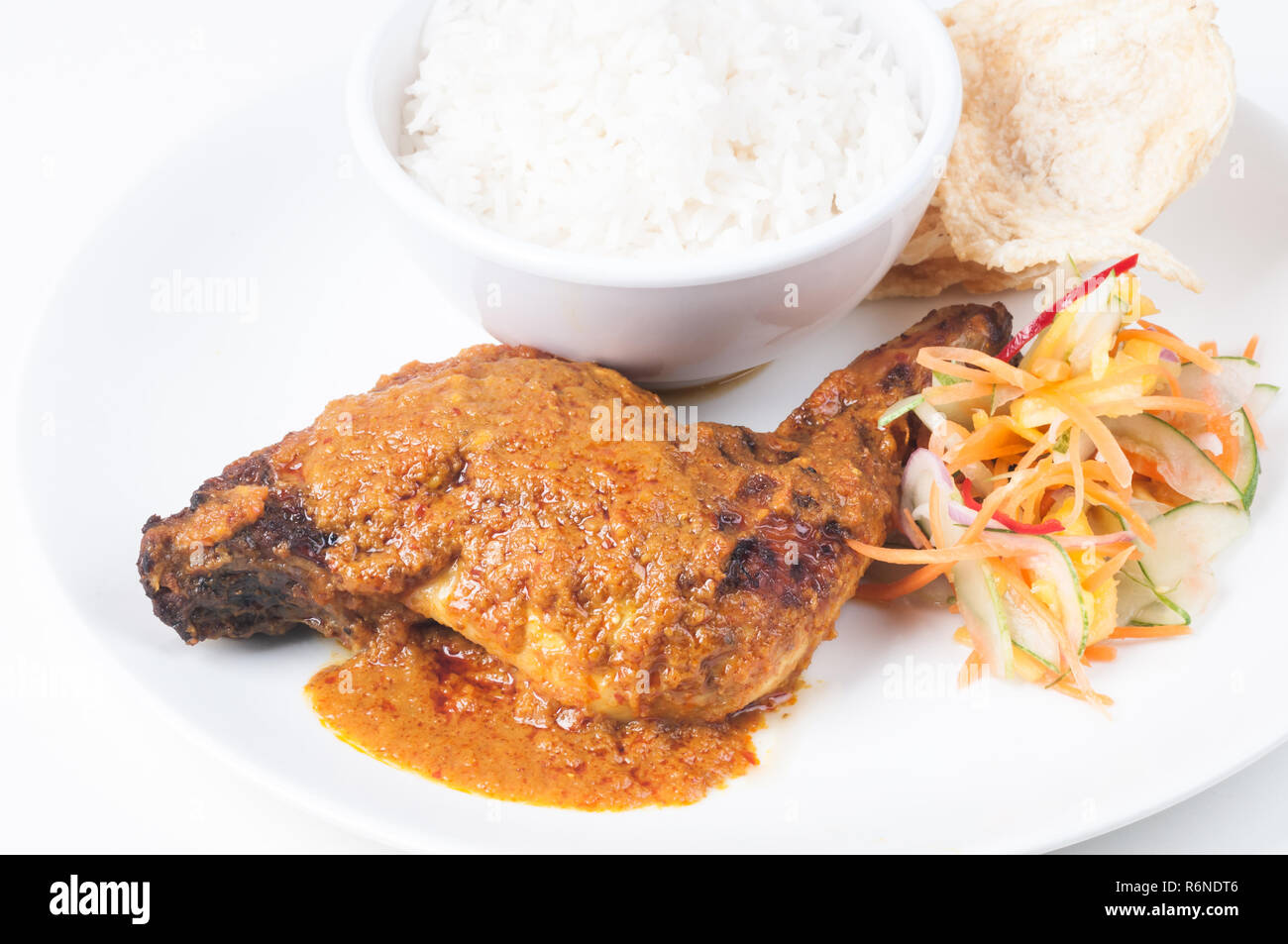 Classic Chicken Rendang with rice and vegetable pickles Stock Photo - Alamy