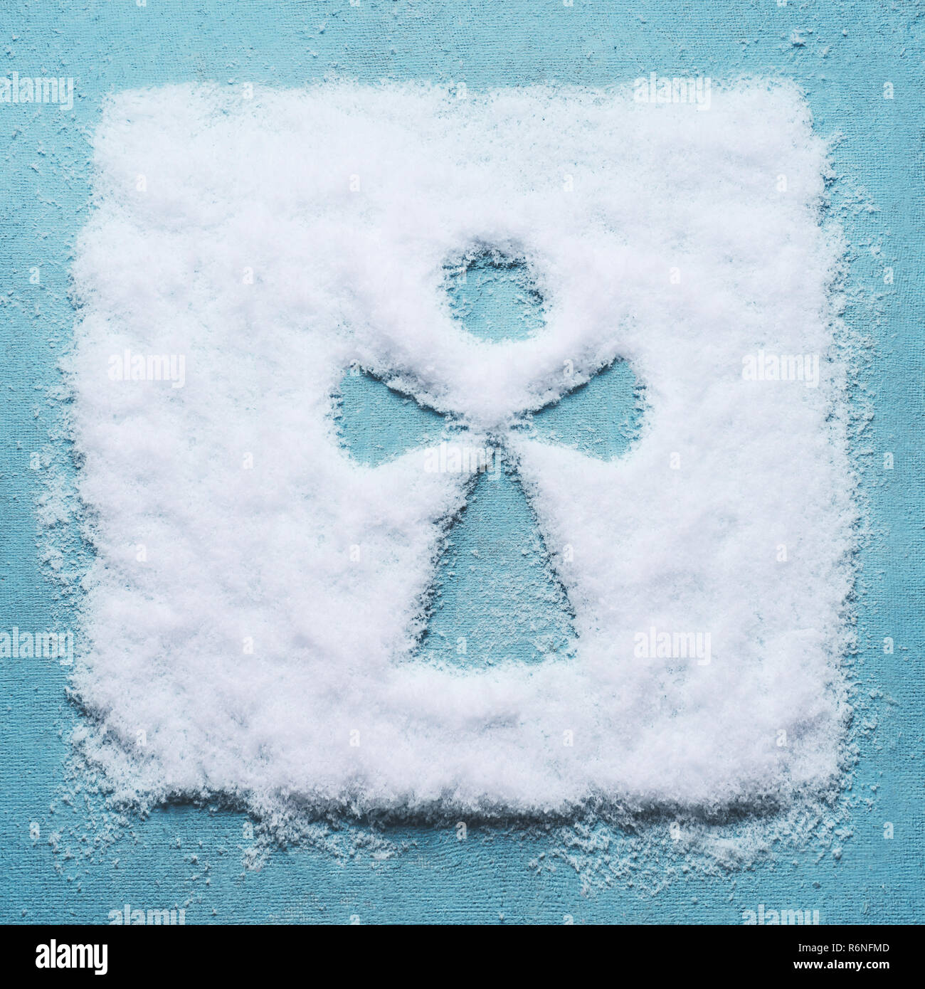 Creative Christmas concept with snow angel symbol silhouette on light ...