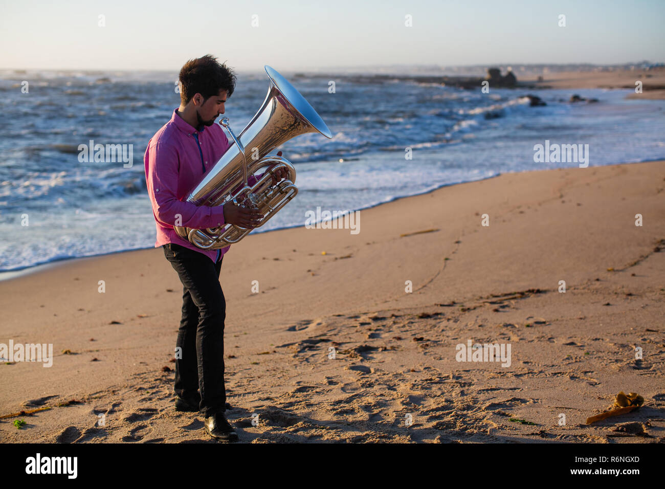 Young musician playing the tuba on the sea coast Stock Photo - Alamy